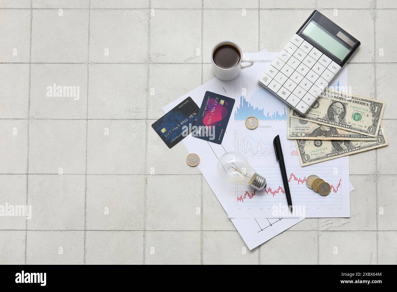 Credit cards, money, calculator and charts on white tiled table. House ...