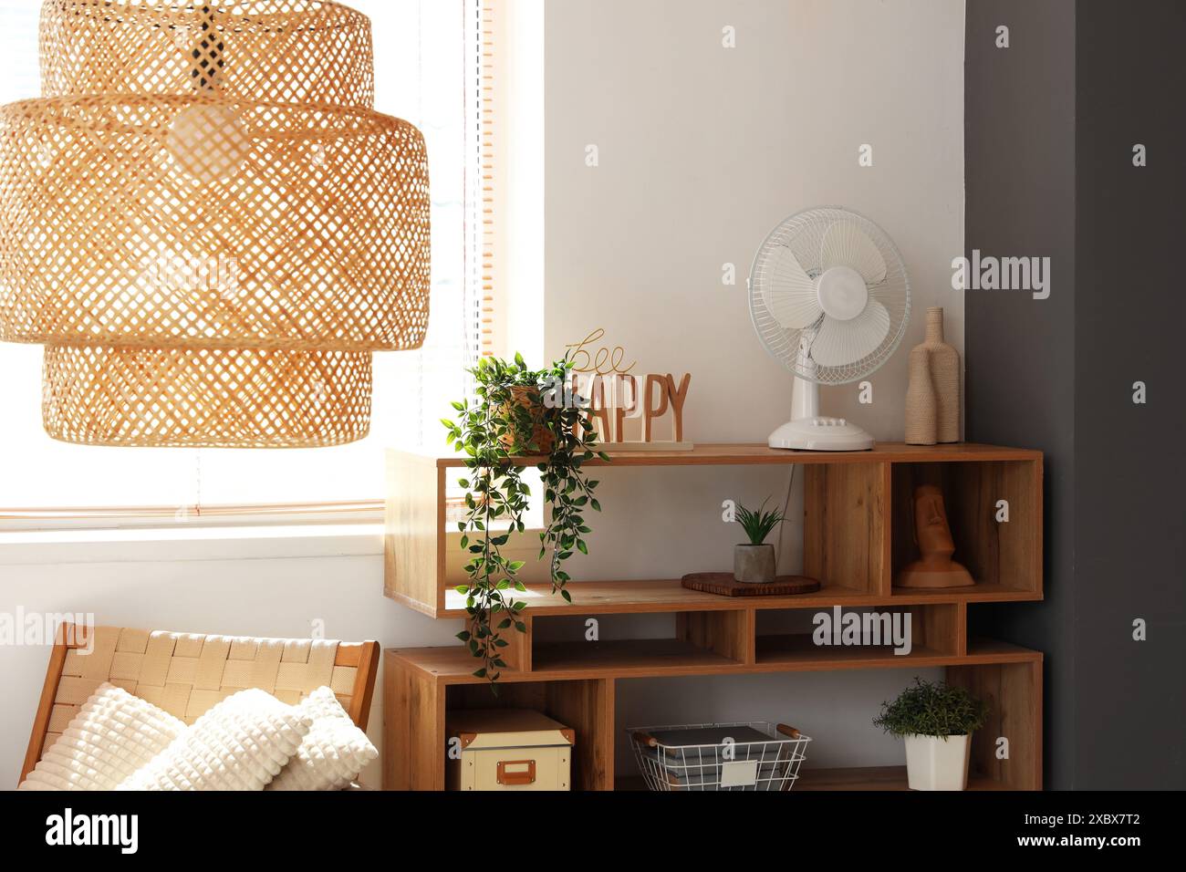 Interior of light living room with modern electric fan on shelf Stock ...