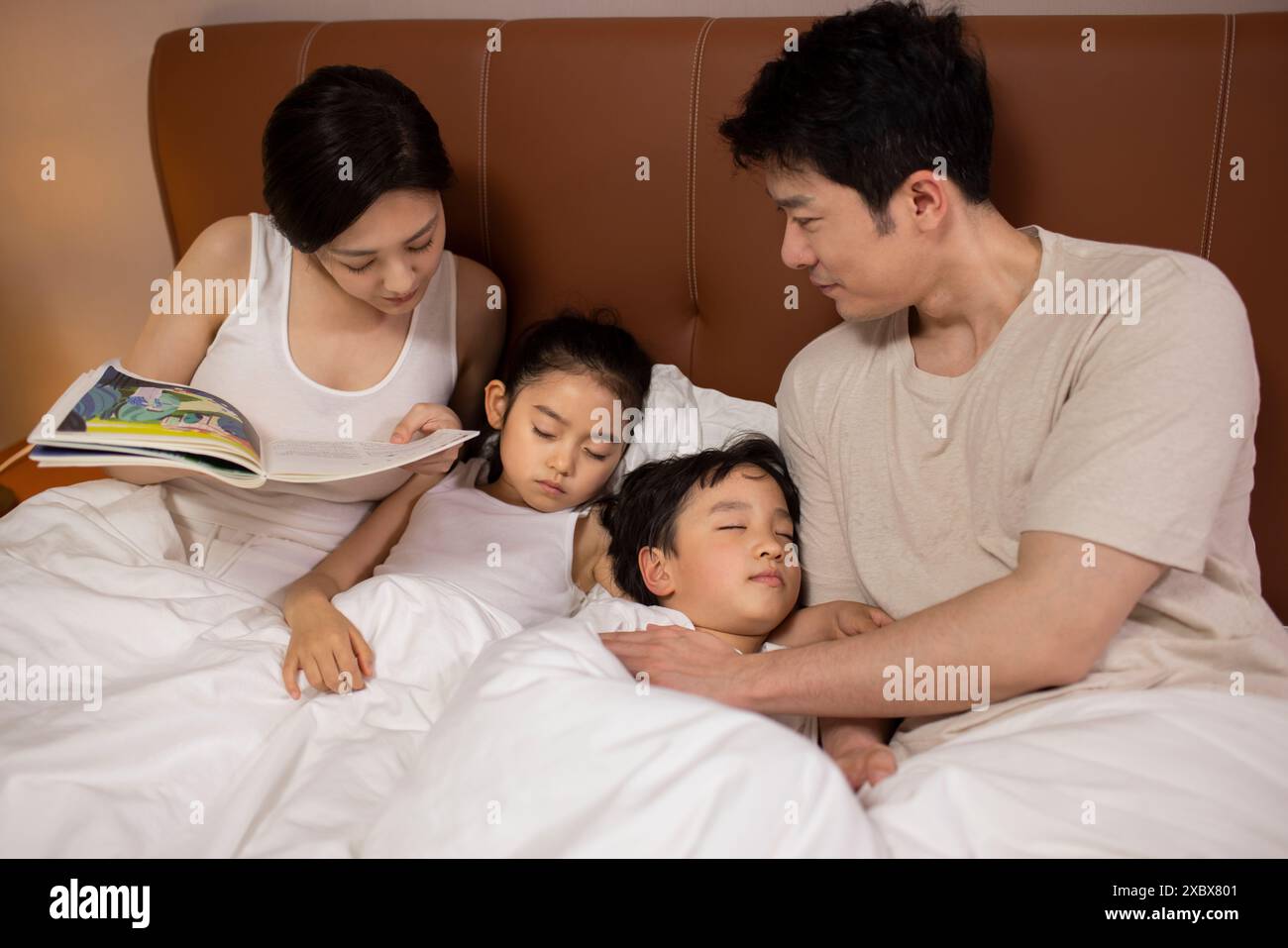 Chinese Parents Putting Kids To Sleep Stock Photo - Alamy