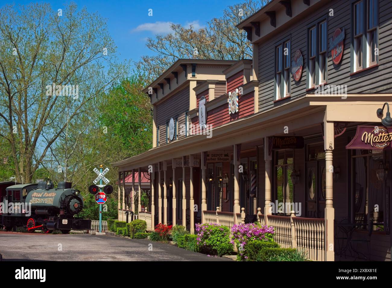 Old shops with a covered walkway and a vintage steam locomotive with ...