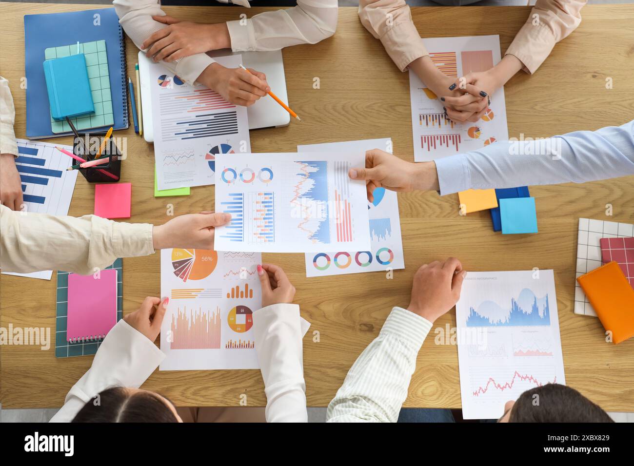 Business people with diagrams working on marketing plan in office, top ...