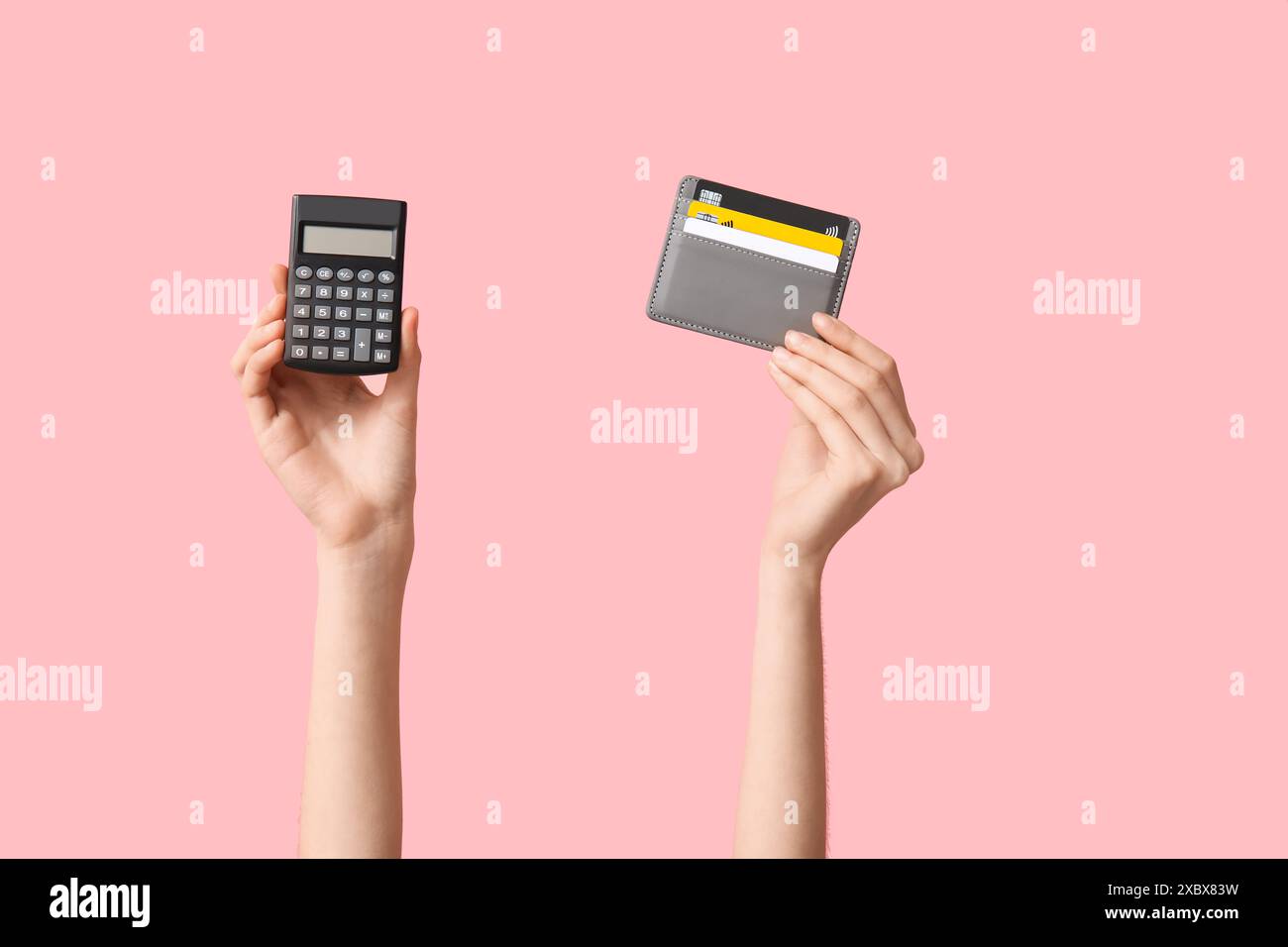 Female hands with credit cards and calculator on pink background Stock ...