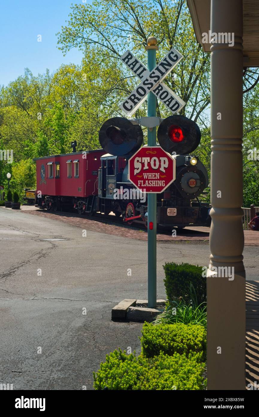 A flashing railroad signal stands as a decorative prop in front of a ...