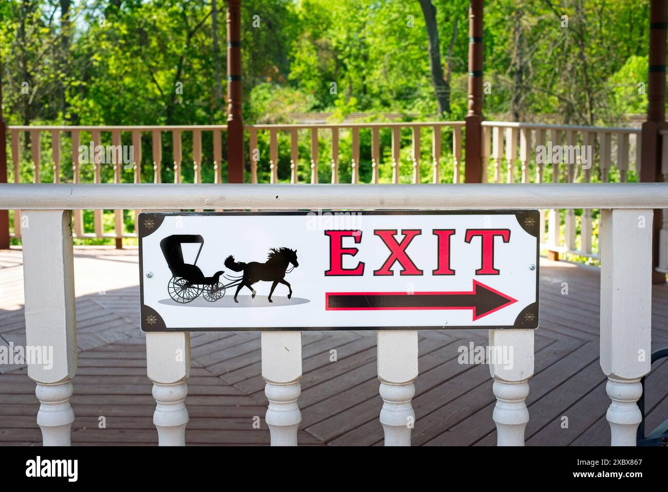 A vintage-style sign with horse and buggy on the village gazebo ...