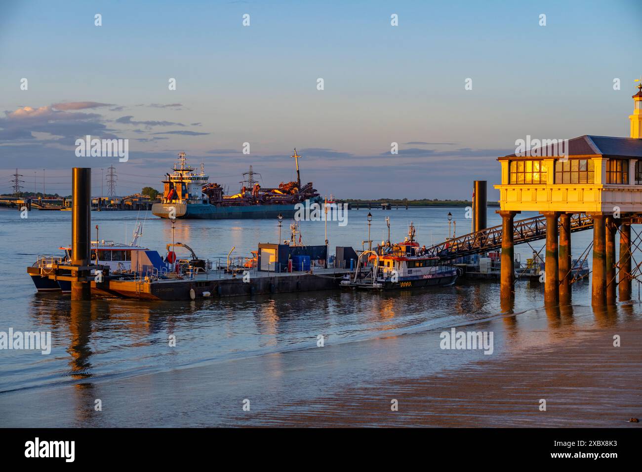 Boat sailing down the Thames and Royal Pier Gravesend Kent at Low tide ...