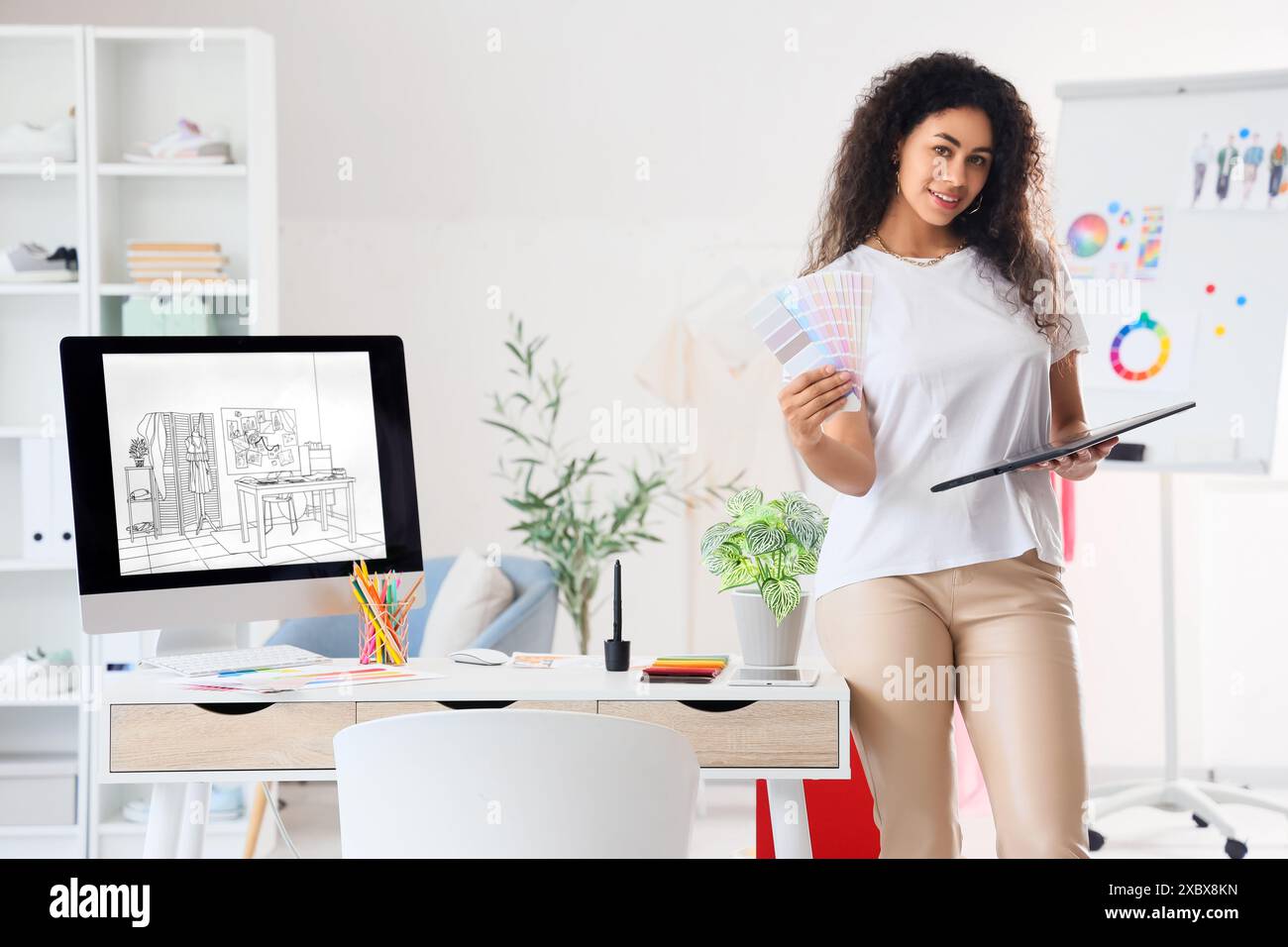 Female African-American graphic designer with tablet and color palettes ...