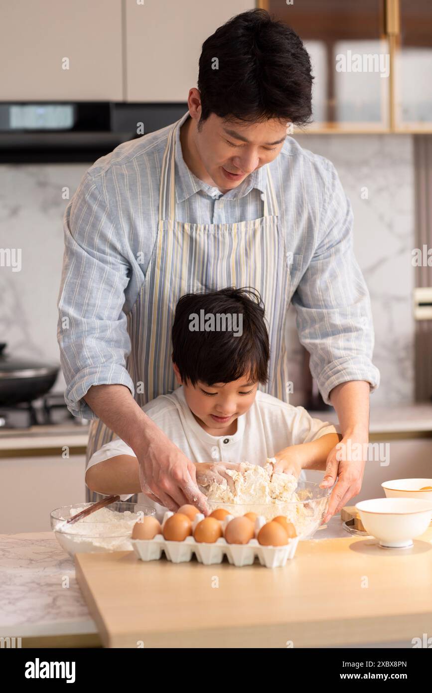 Father And Son Cooking In The Kitchen Stock Photo - Alamy