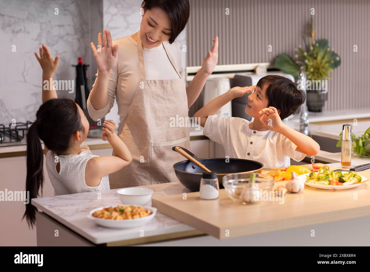 Mum And Kids Cooking In The Kitchen Stock Photo - Alamy