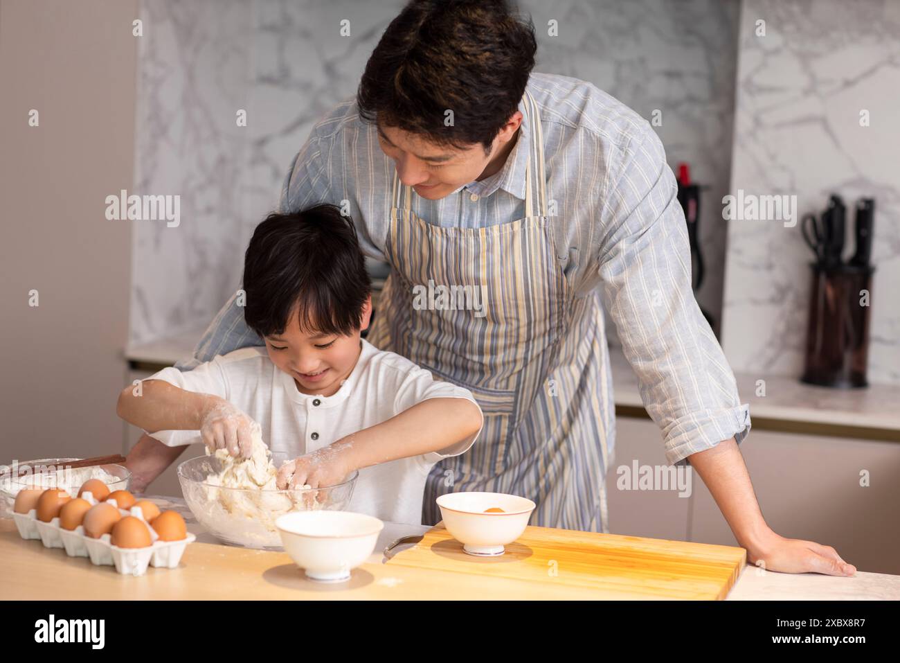 Indian father and son cooking hi-res stock photography and images - Alamy