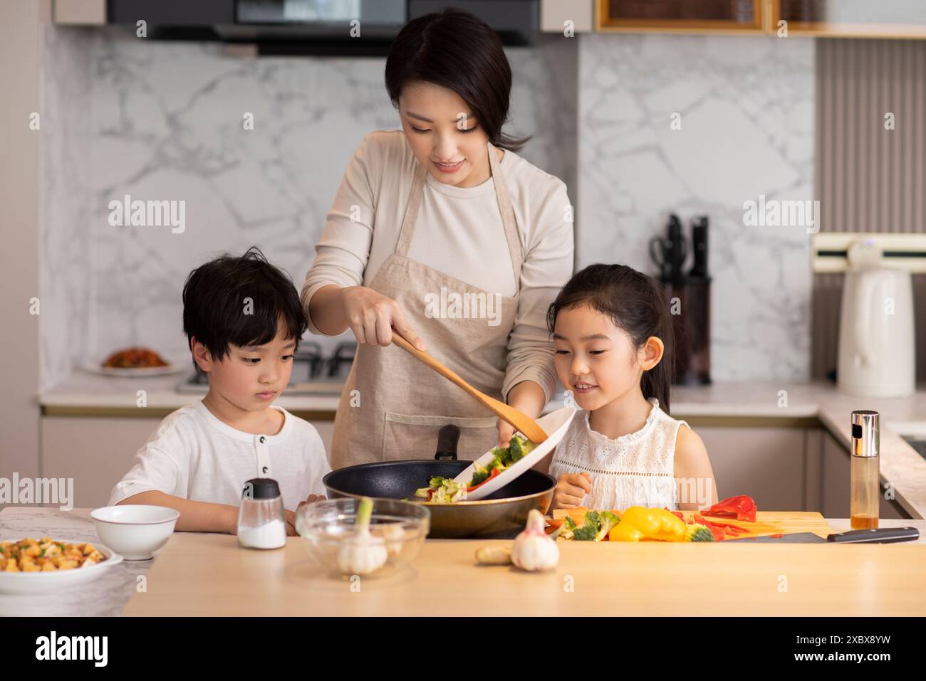 Indian mother and son in kitchen hi-res stock photography and images ...