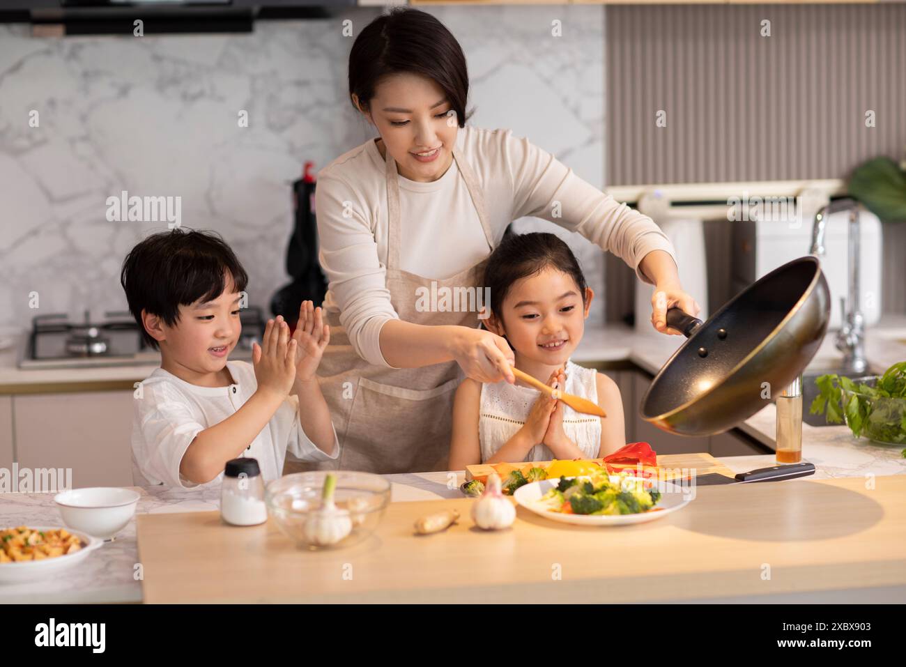 Indian mother and son in kitchen hi-res stock photography and images ...