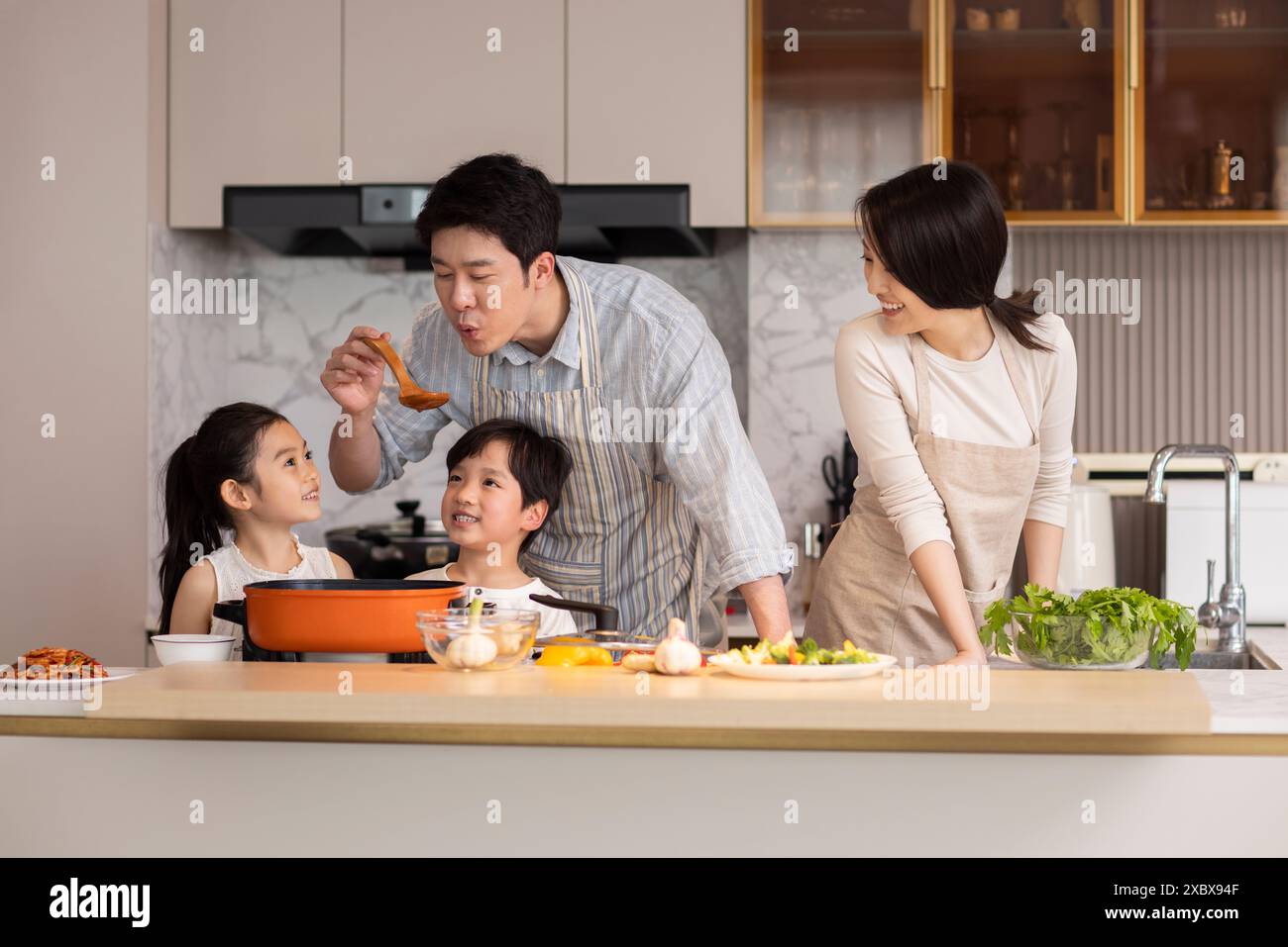 Family Cooking In The Kitchen Stock Photo - Alamy
