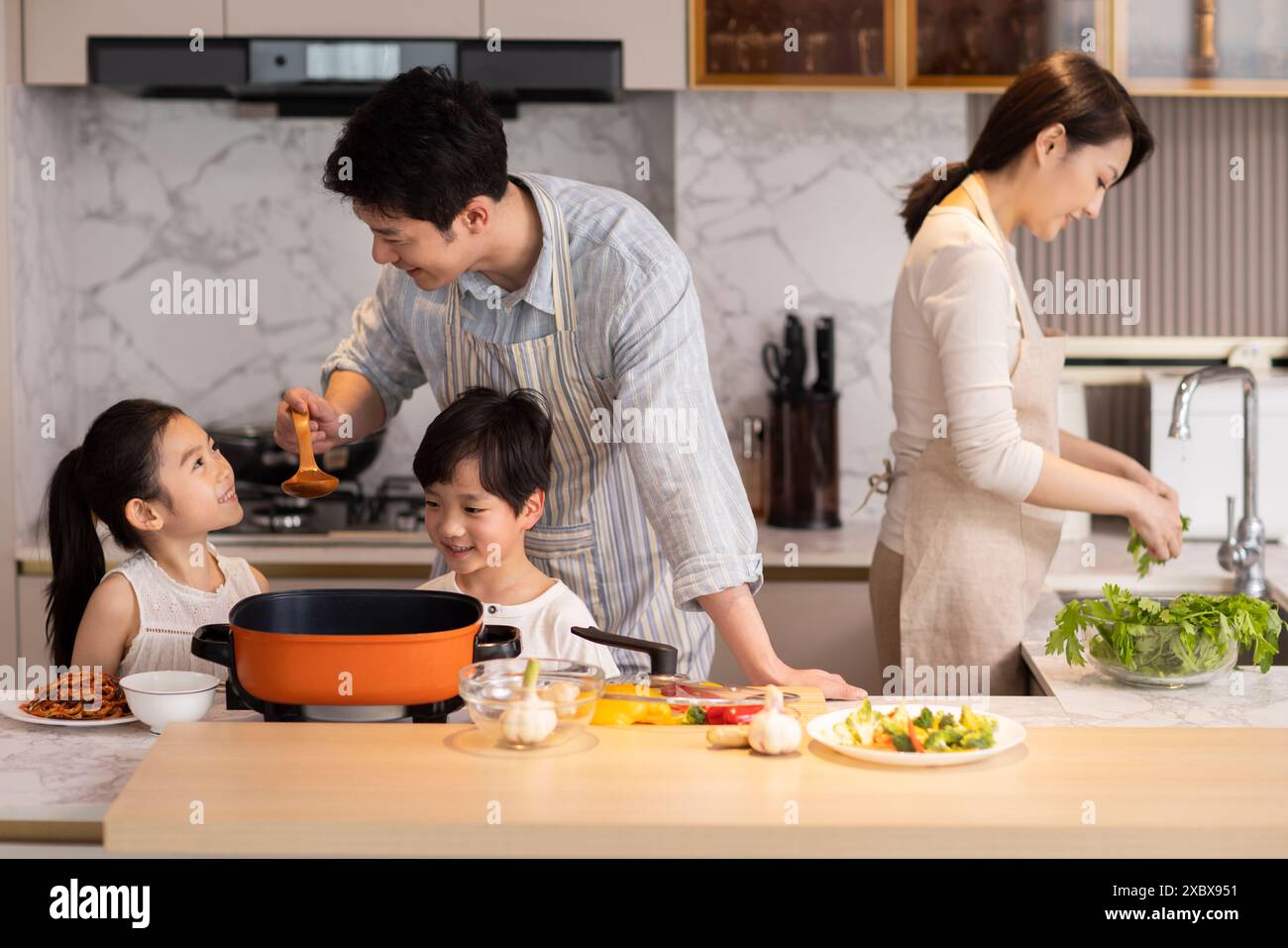 Family Cooking In The Kitchen Stock Photo - Alamy