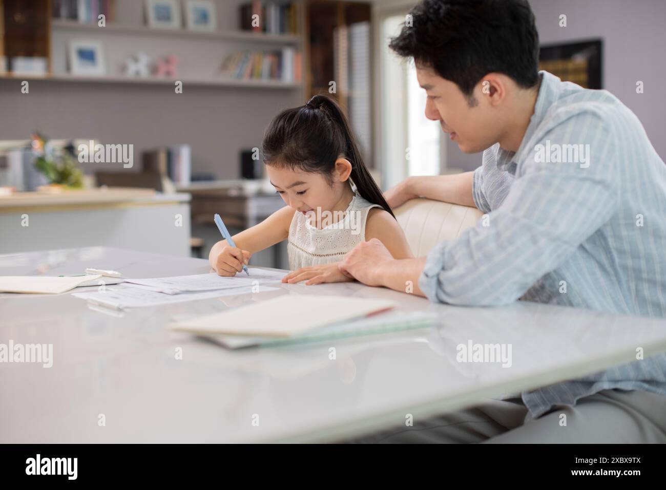 Dad Helping Daughter With Her Homework Stock Photo - Alamy