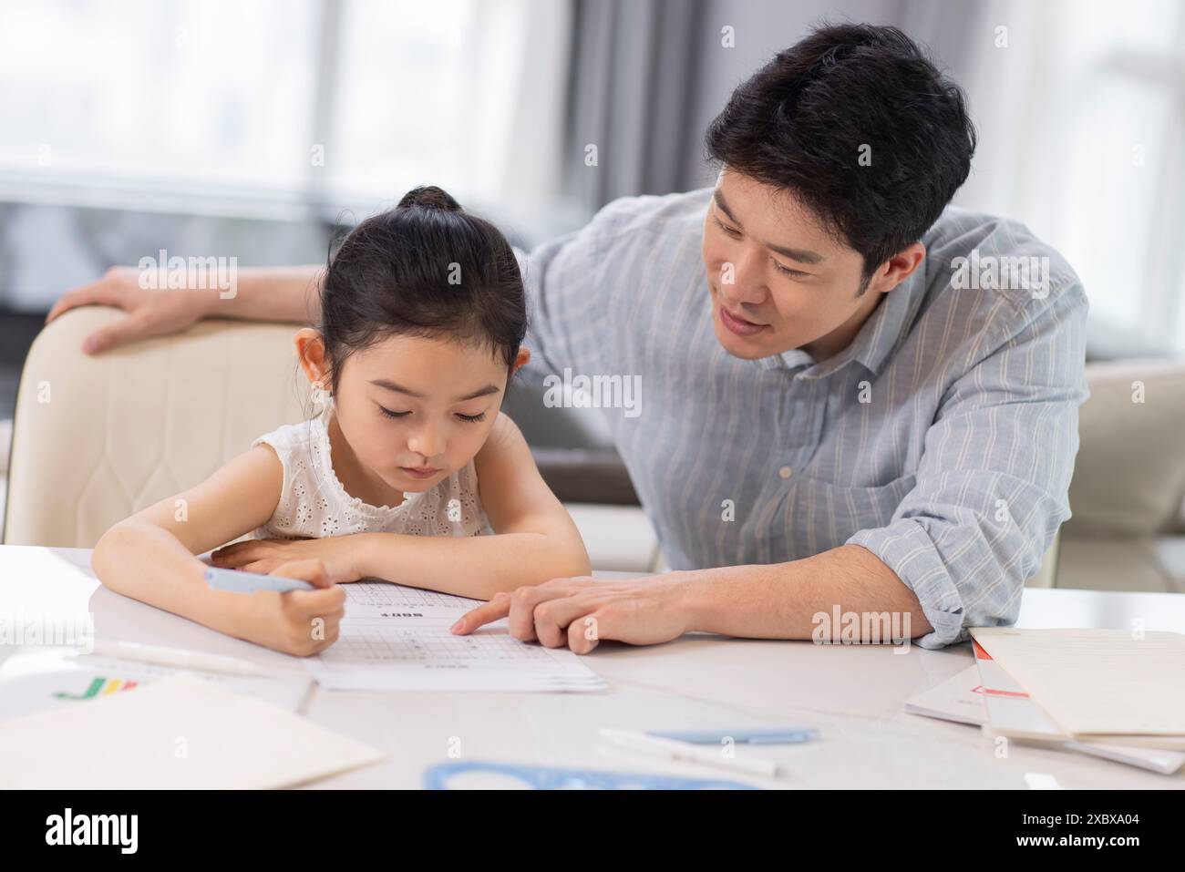 Dad Helping Daughter With Her Homework Stock Photo - Alamy