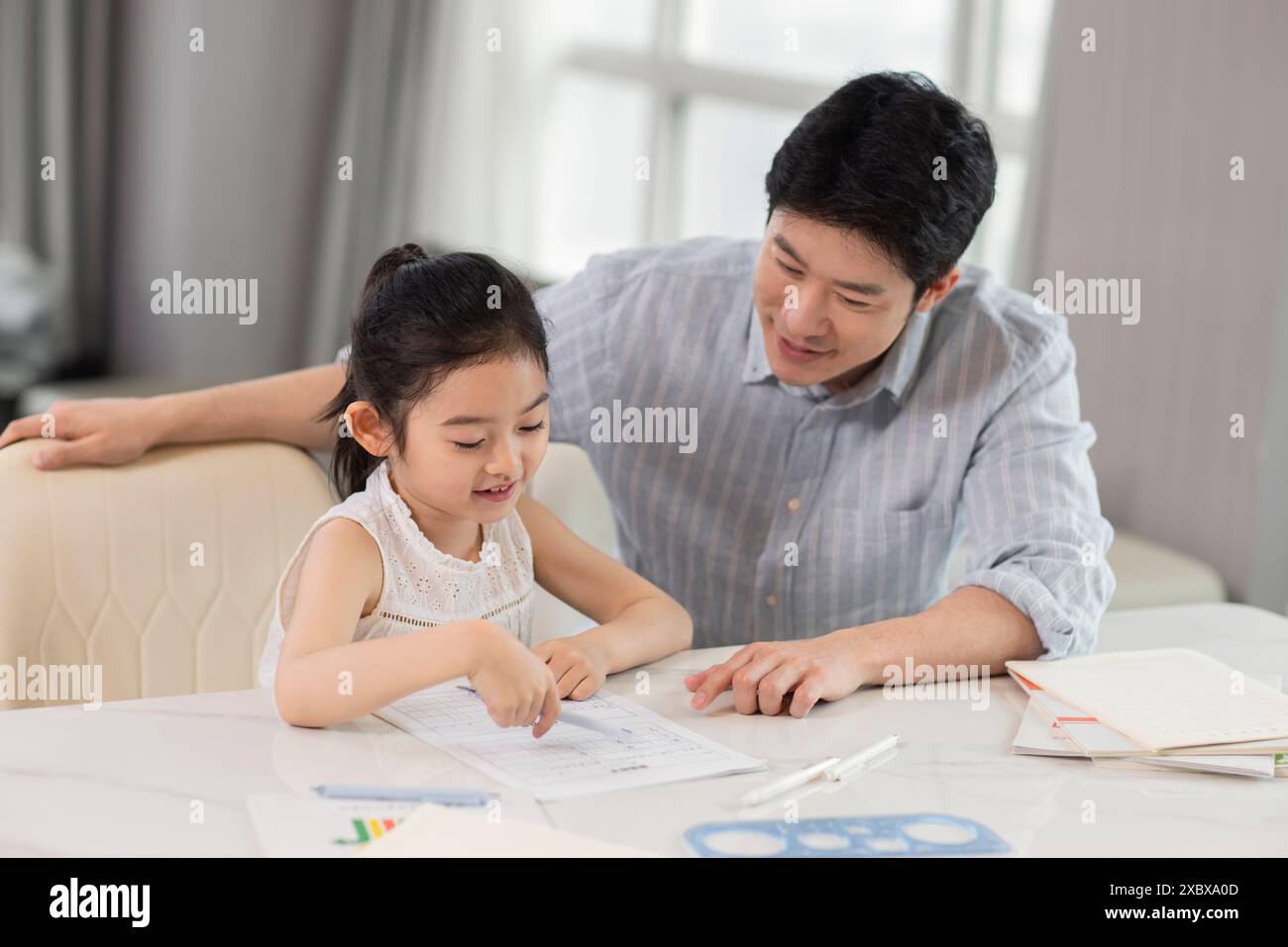 Dad Helping Daughter With Her Homework Stock Photo - Alamy
