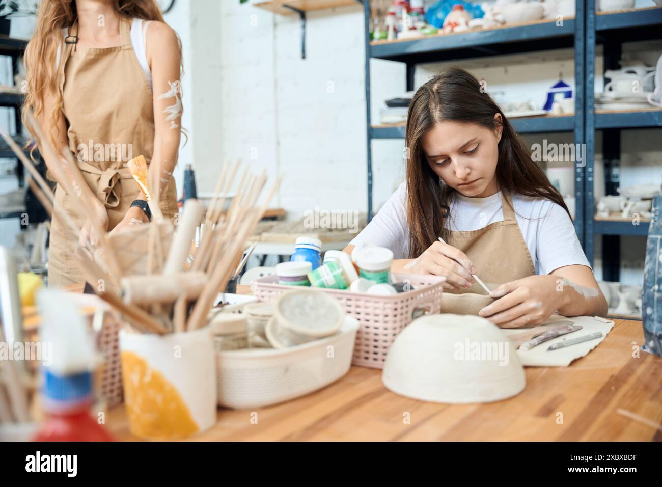 Woman making pattern on clay hi-res stock photography and images - Alamy