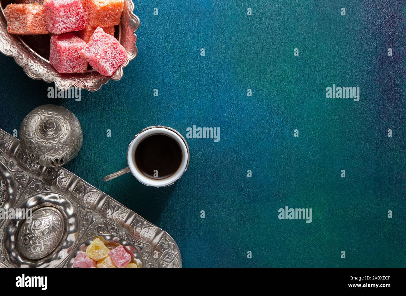 Traditional Turkish coffee and Turkish delight on a painted dark blue ...