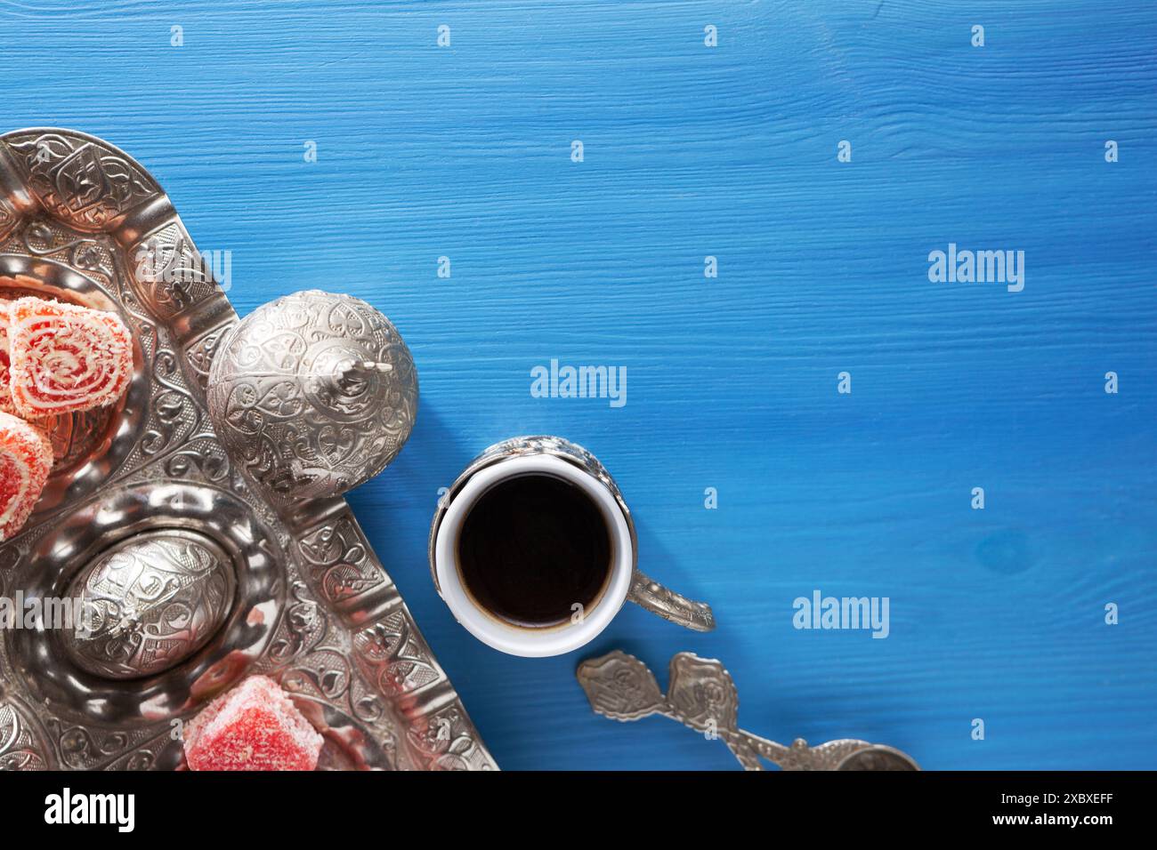 Traditional turkish coffee and turkish delight on blue wooden table ...