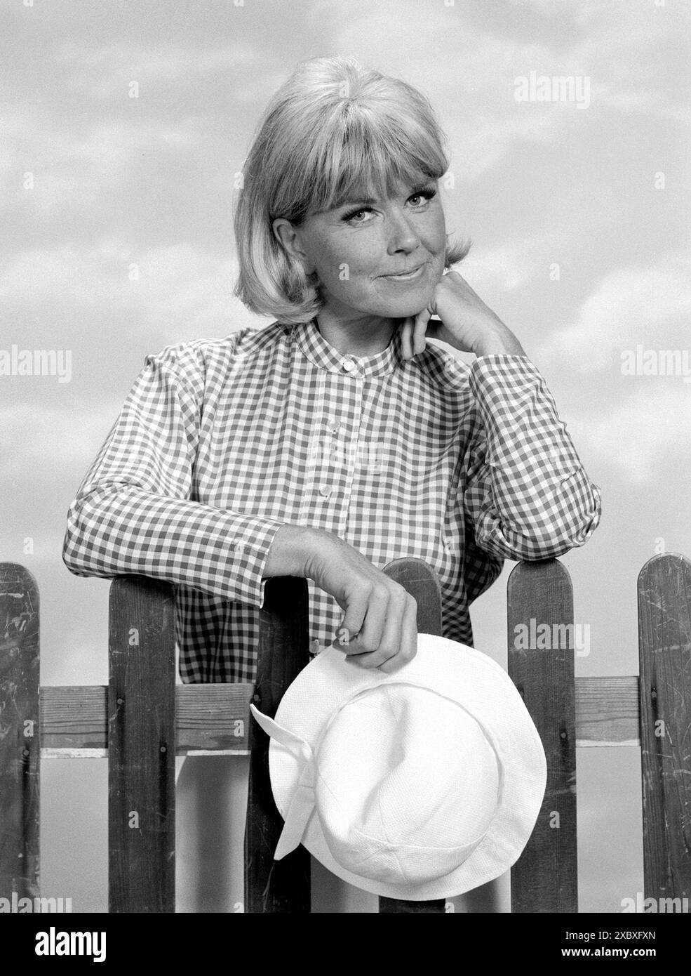 DORIS DAY, American actress Doris Day holds her hat and leans against a ...