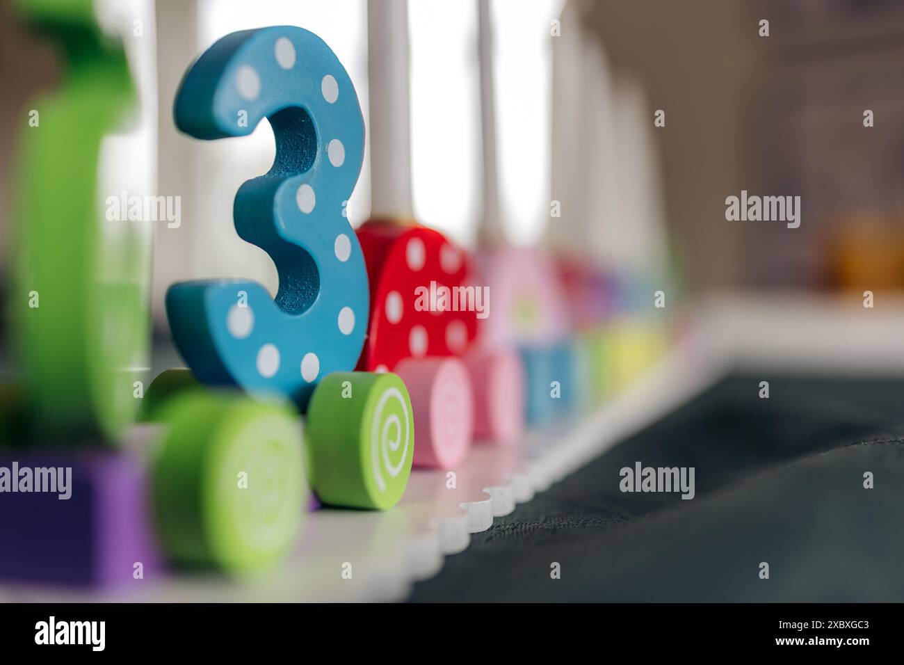 A wooden candle holder shaped like a train for birthdays, with the ...