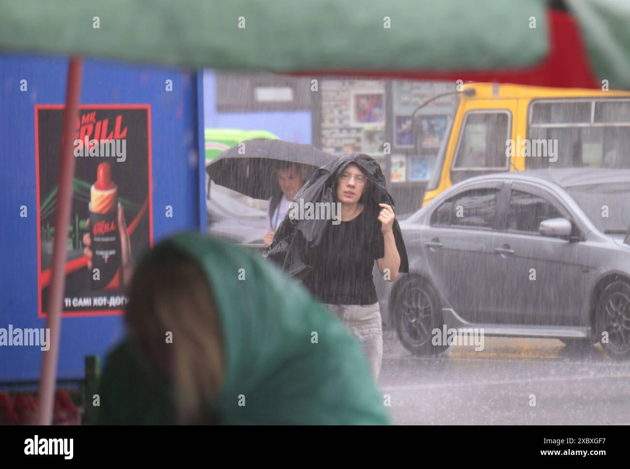 Non Exclusive: KYIV, UKRAINE - JUNE 12, 2024 - A woman covers her head ...