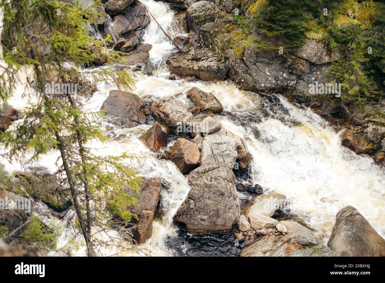 A loud river stream directly before a giant waterfall in Norwegian ...