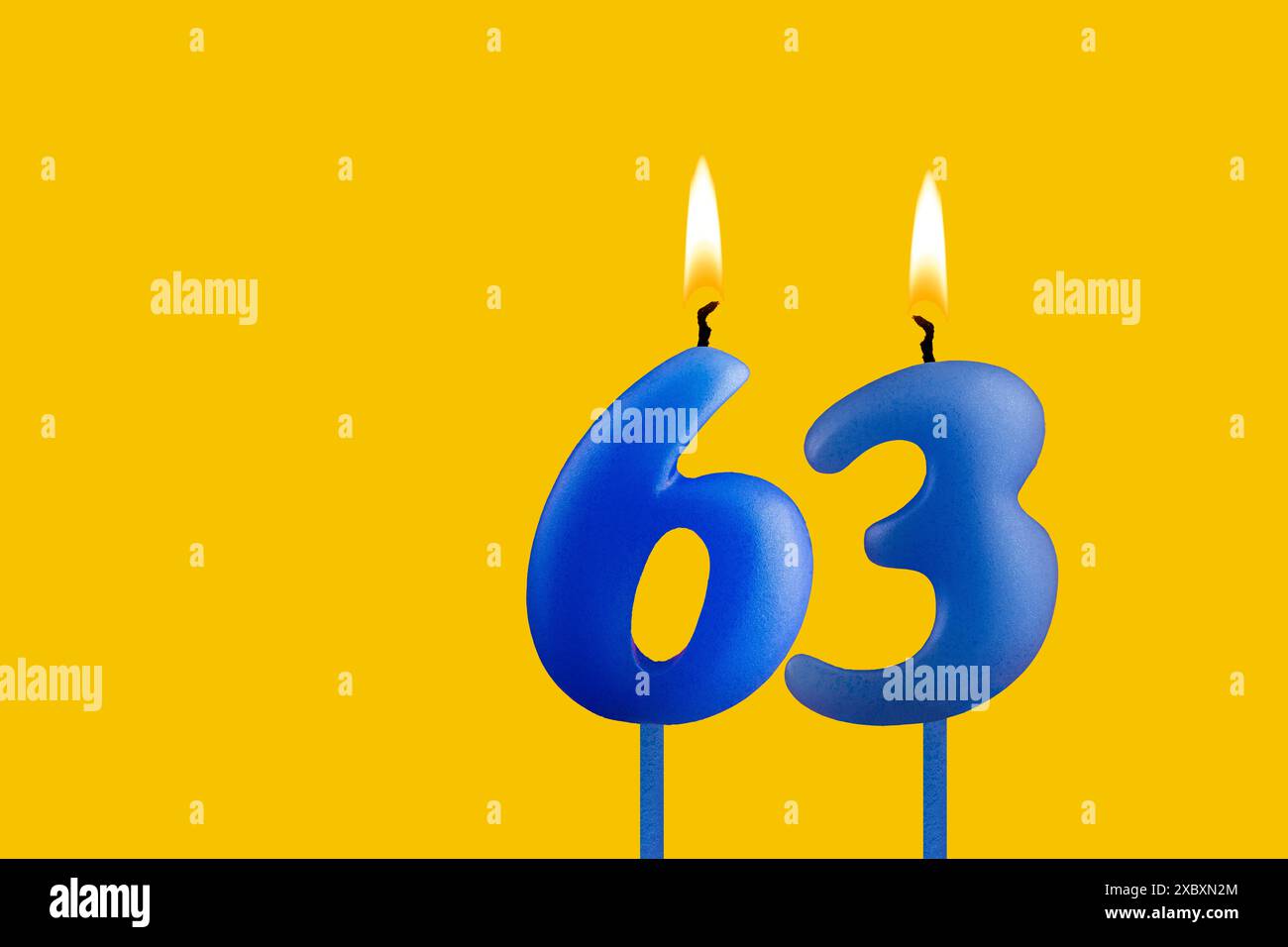 Blue birthday candle on yellow background - Number 63 Stock Photo - Alamy