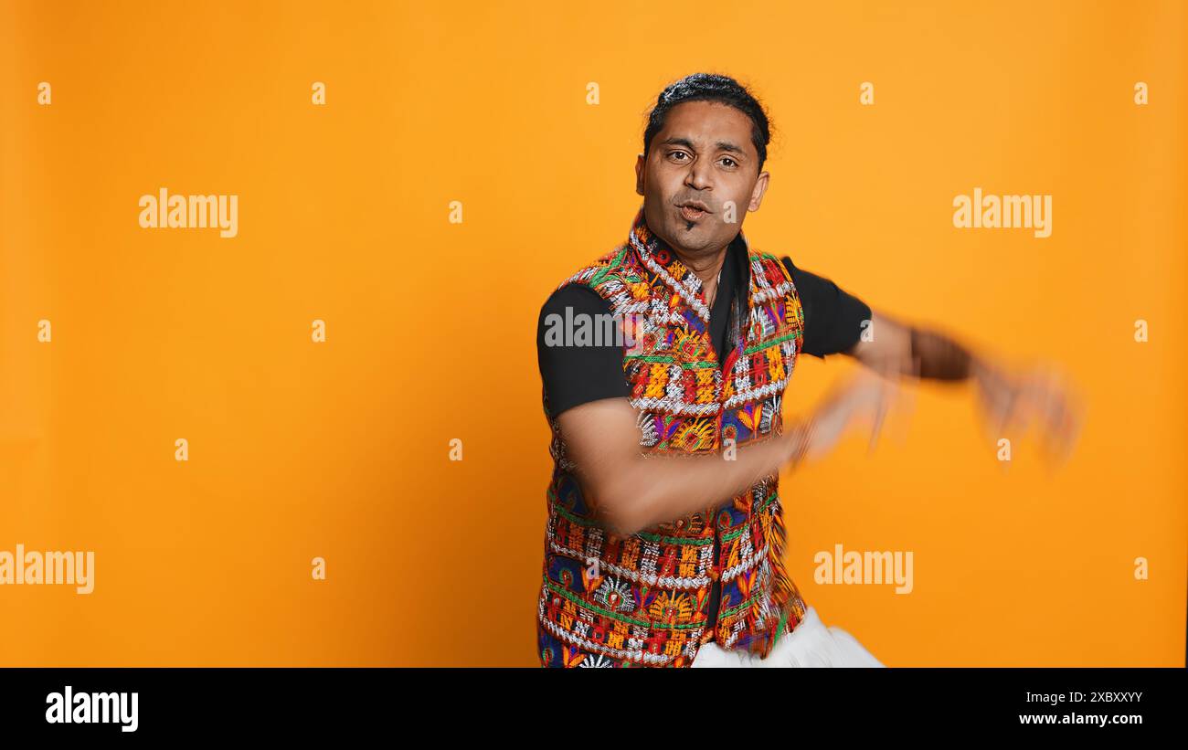 Ecstatic person wearing traditional indian attire doing energetic dance ...
