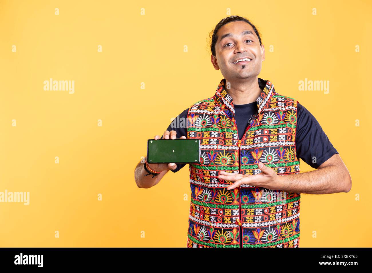Portrait of happy content creator in traditional clothing recommending ...