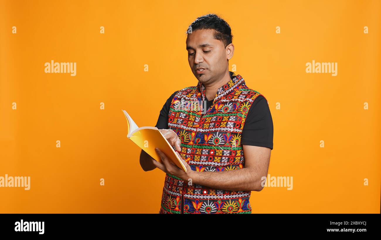 Indian man reading book, having fun and enjoying characters and plot ...