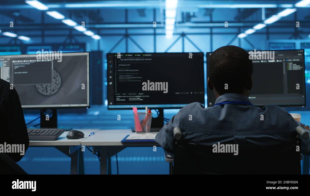 Person with disability next to multiracial coworkers in data center ...
