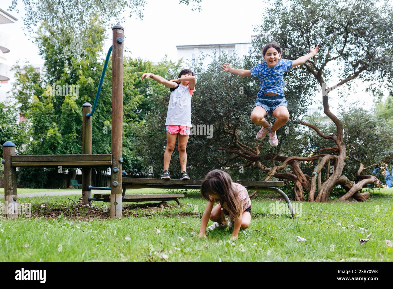 three children jumping from the wooden bench Stock Photo - Alamy