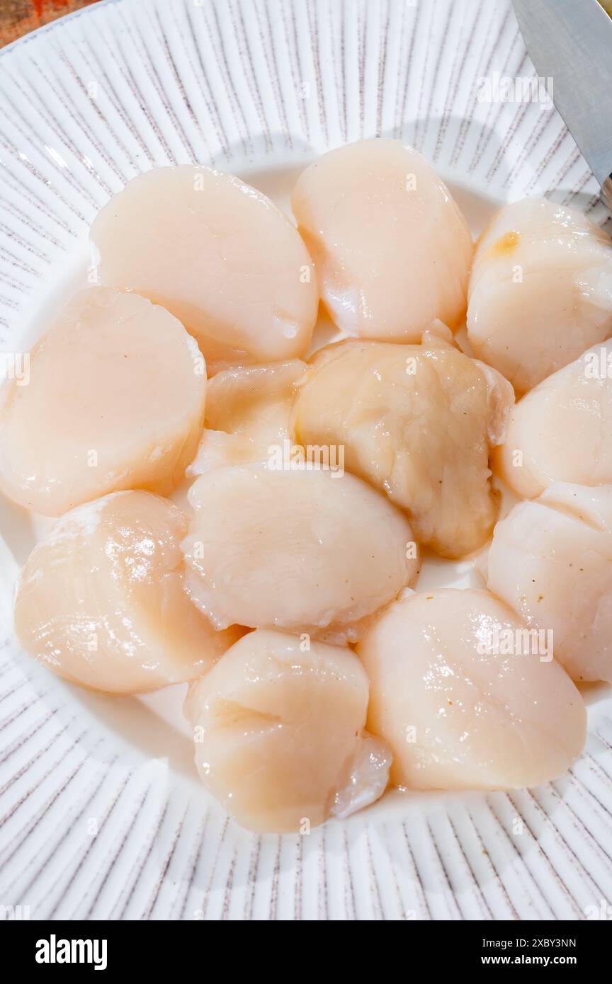Atlantic bay cleaned scallops coquille St. James sea shells on plate ...