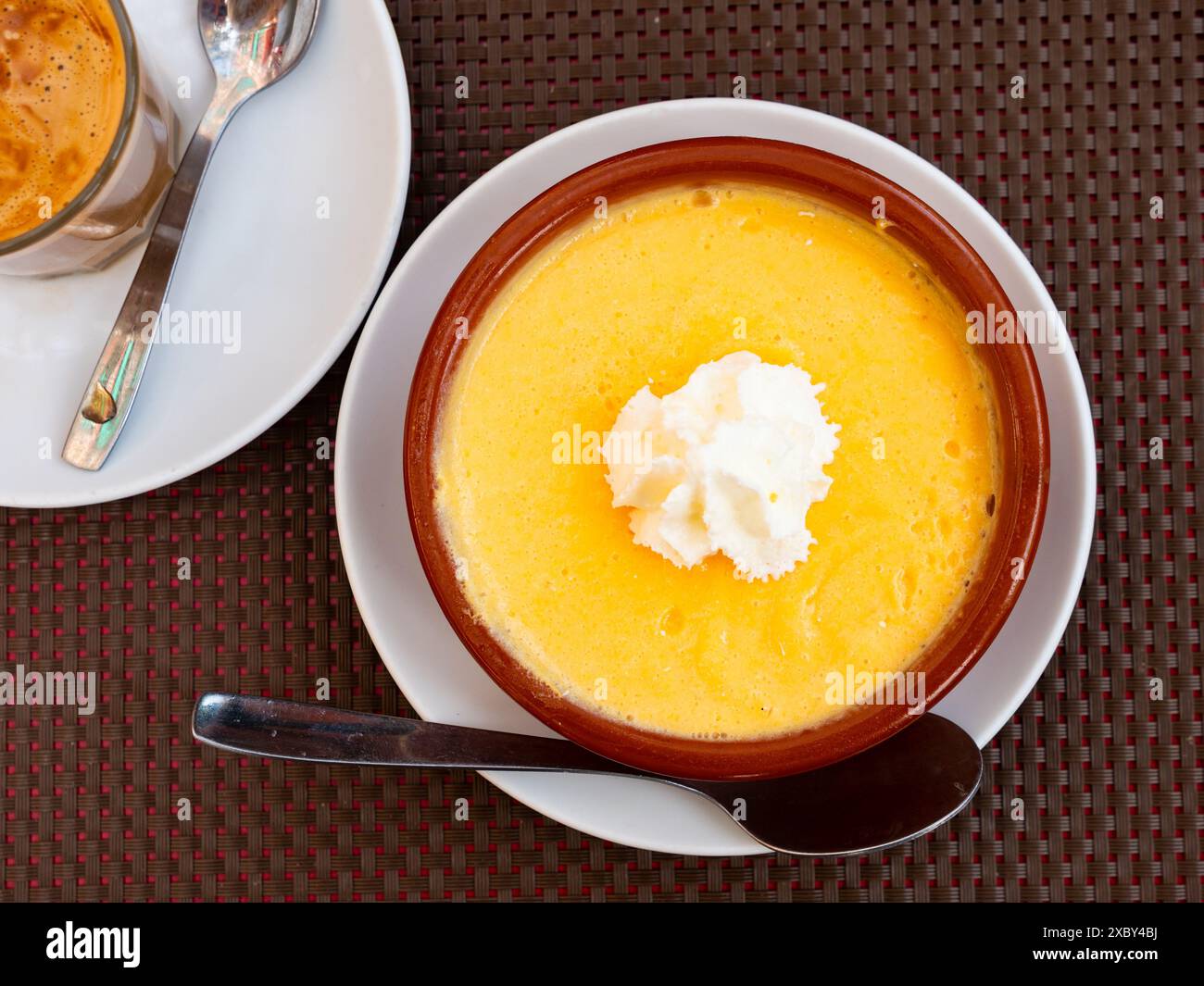 Light mango mousse with whipped cream in earthen bowl Stock Photo - Alamy