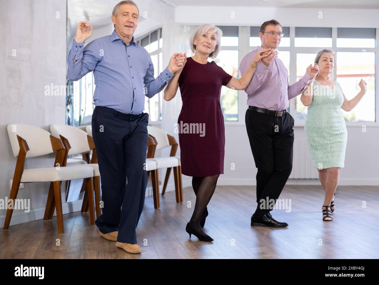 Positive adults forming line while rehearsing traditional Irish ...