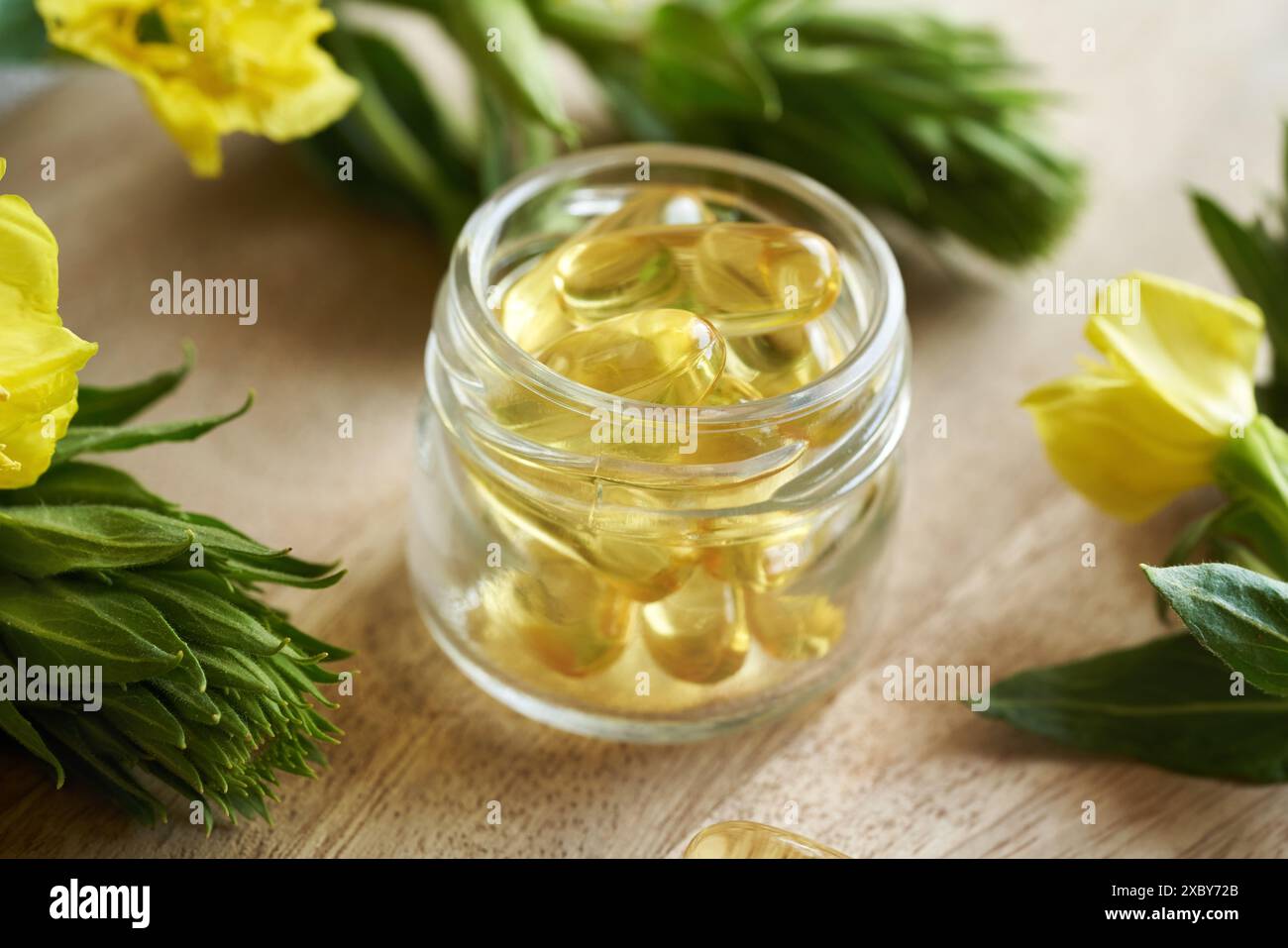 A glass bottle containing gel capsules of evening primrose oil with ...