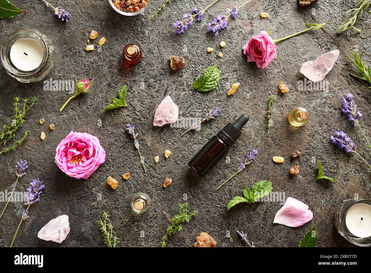 Dark background with bottles of aromatherapy essential oil, myrrh ...