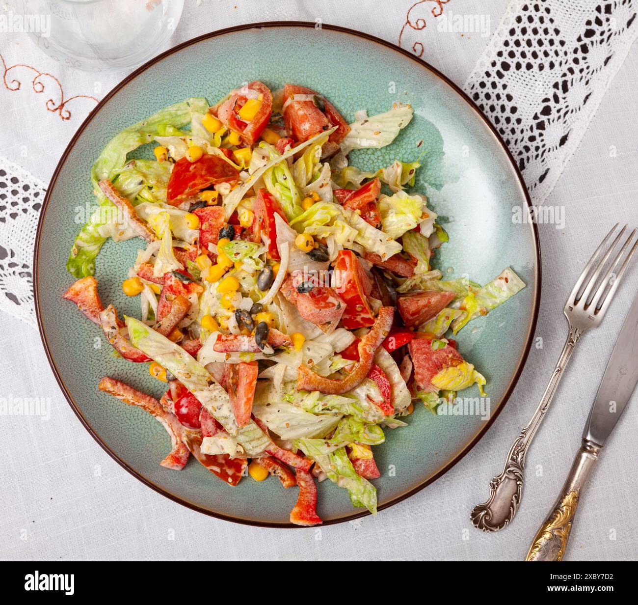 On plate, portion is laid out with pim salad of corn, cabbage ...