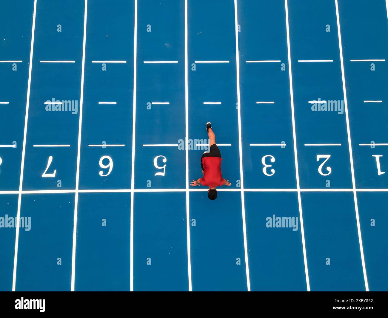 aerial bird's-eye view captured by a drone, this image depicts a runner ...