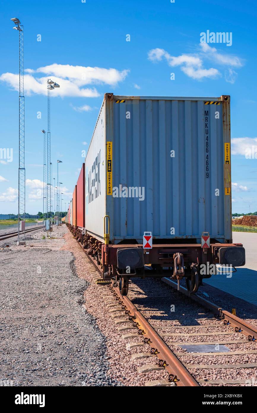 Train with containers on a loading area, Sweden Stock Photo - Alamy