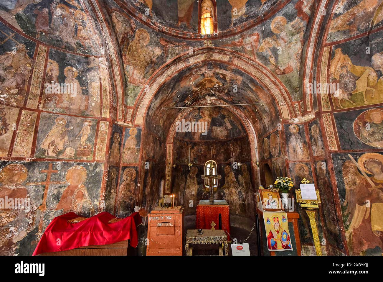 Interior of a church covered with frescoes and religious icons, several ...