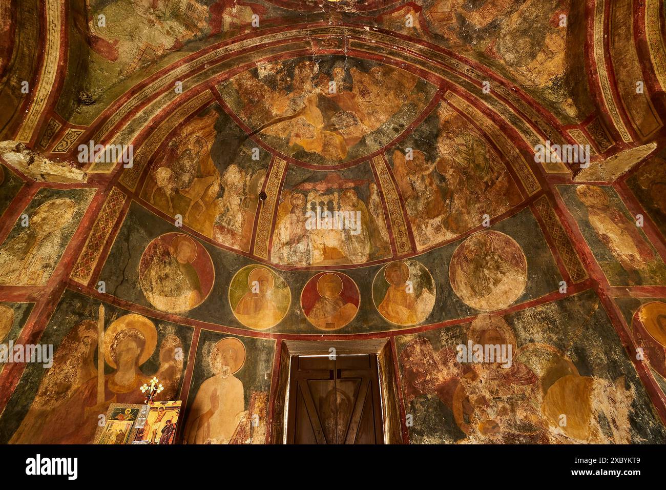 A frescoed church interior showing circular portraits and religious art ...