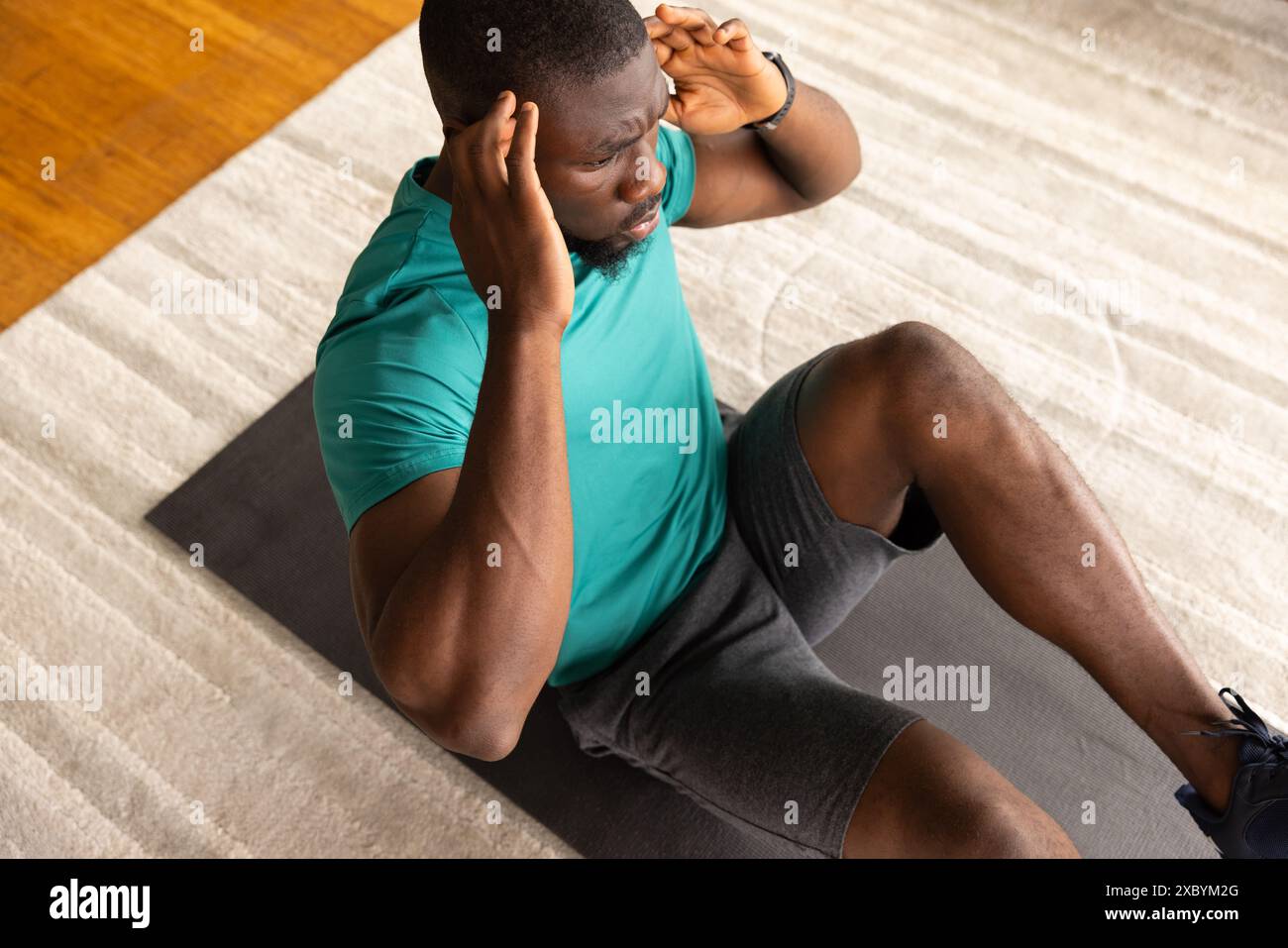 Fit African American male doing sit-ups on yoga mat, strong and healthy ...