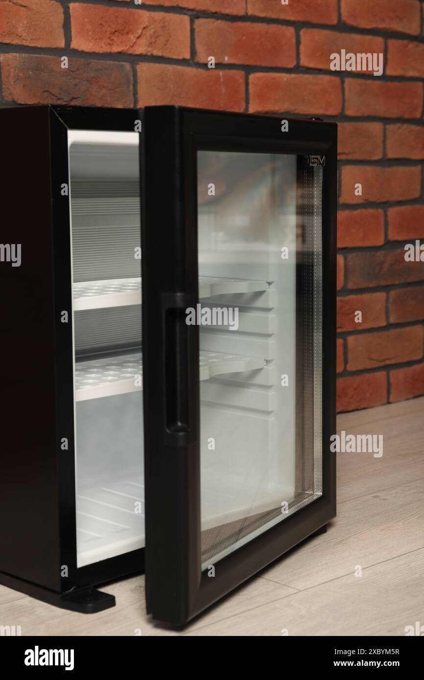 Empty mini refrigerator near brick wall, closeup Stock Photo - Alamy