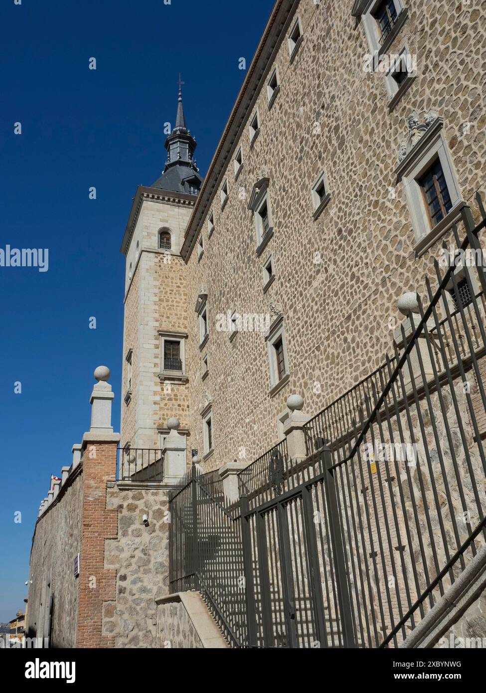 Castle wall with stairs and towers under a blue sky, Toledo, Spain ...