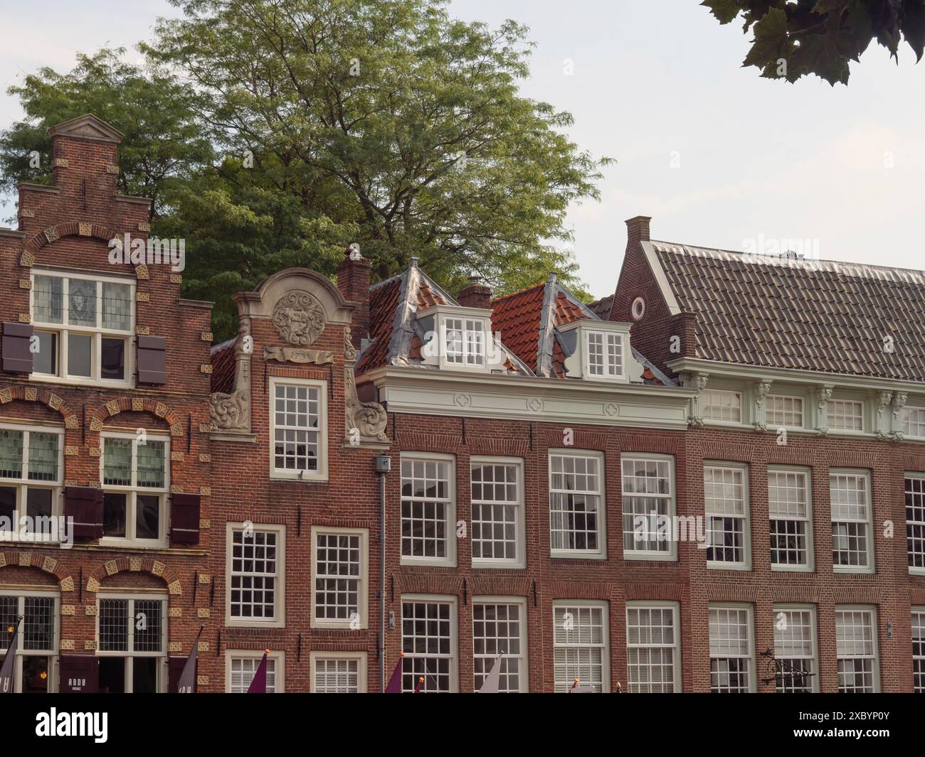 Rows of historic brick buildings with ornate facades and trees in the ...