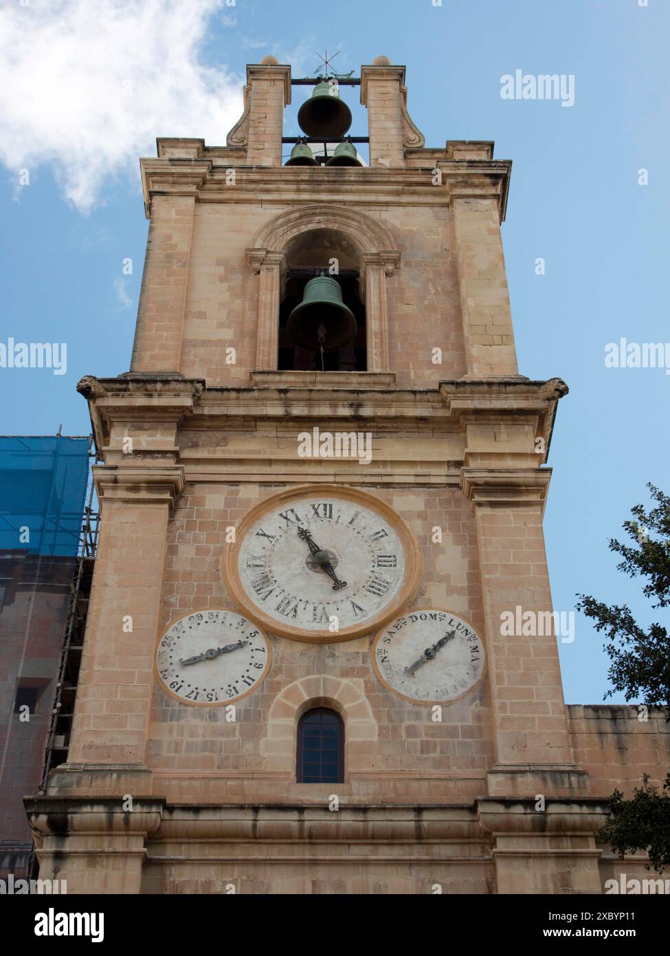 Detail of a historic bell tower with a clock and two clock faces under ...