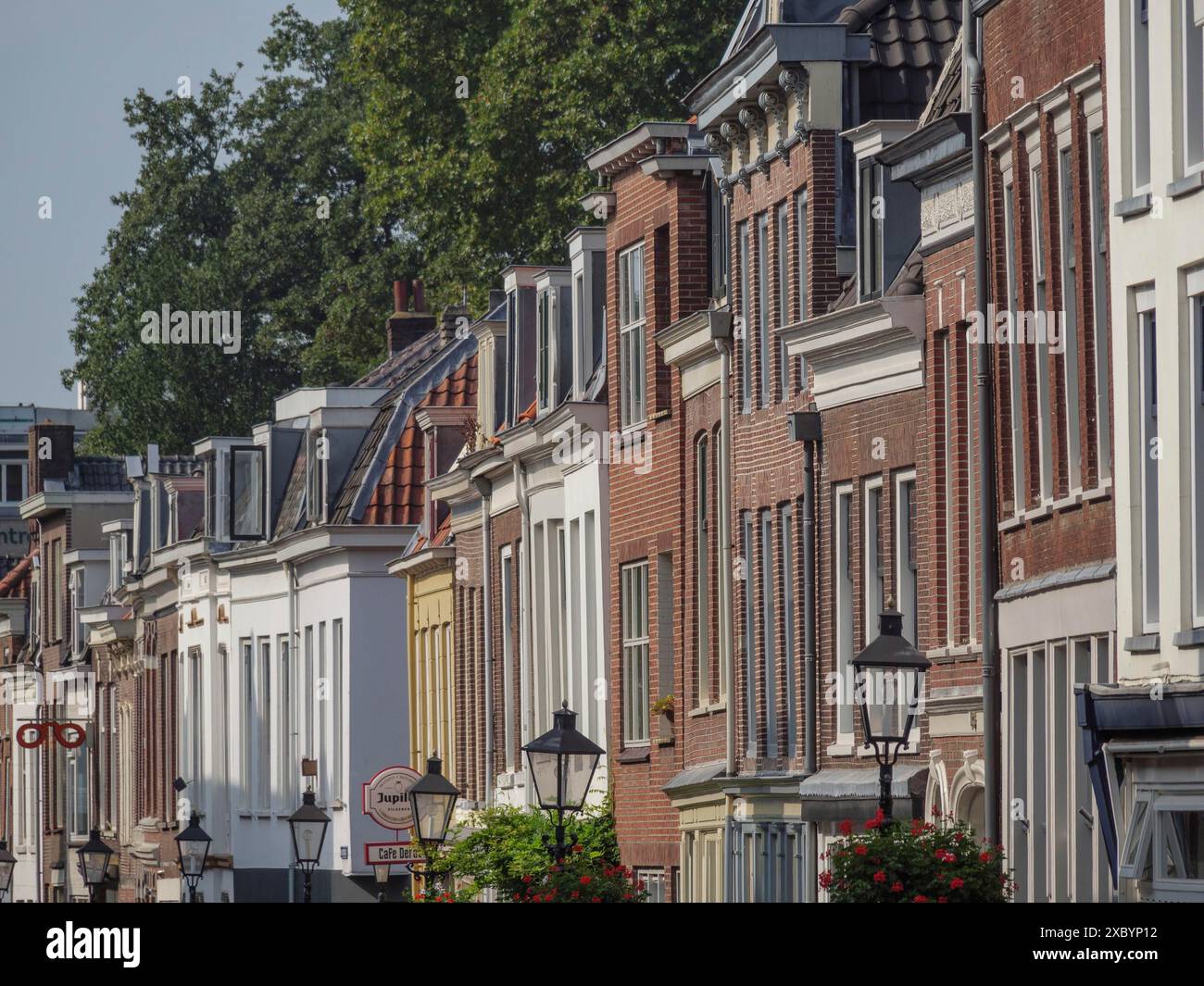 Historic row of houses along a quiet street lined with lanterns in a ...