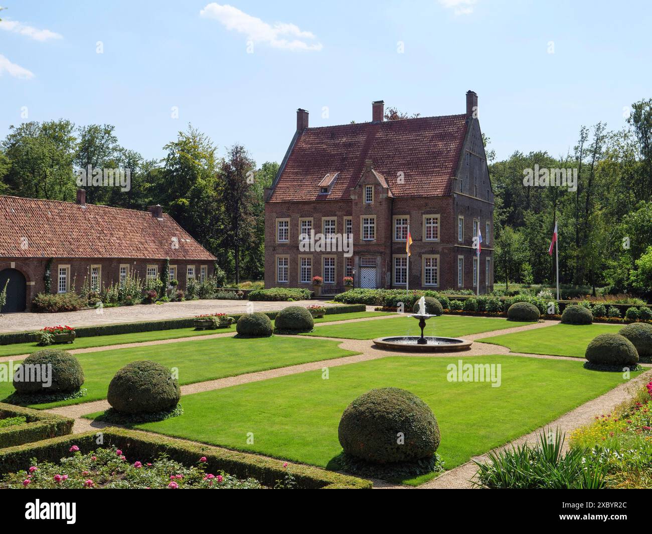 Large manor house with magnificent gardens and fountain, framed by ...